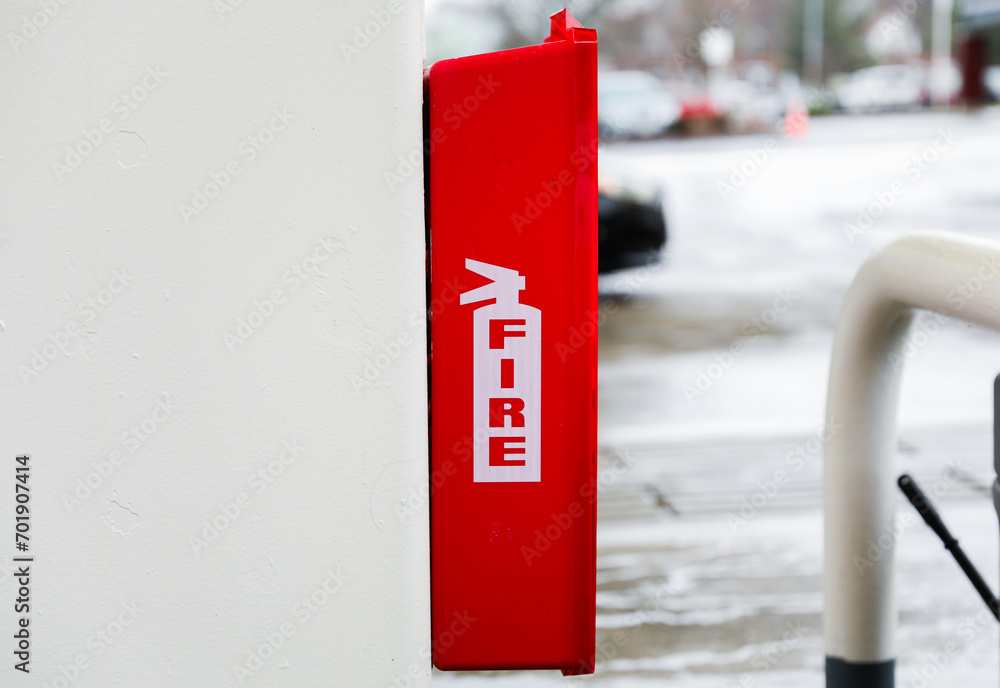Red and white fire extinguisher sign on wall indicating emergency ...