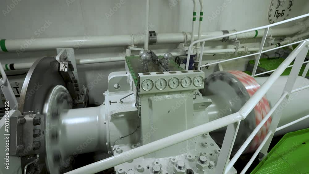 Main shaft with braking system rotates in motor room of vessel. Shaft ...