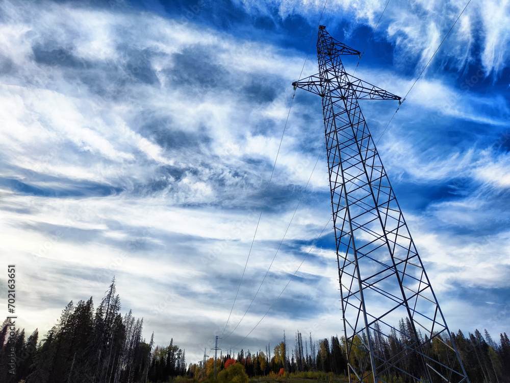 Power lines on a hill, hill or in the mountains against a blue sky with ...