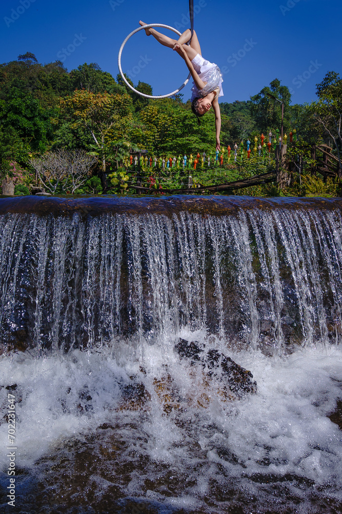 Beautiful Asian girl performing show aerial hoop or aerial ring in ...