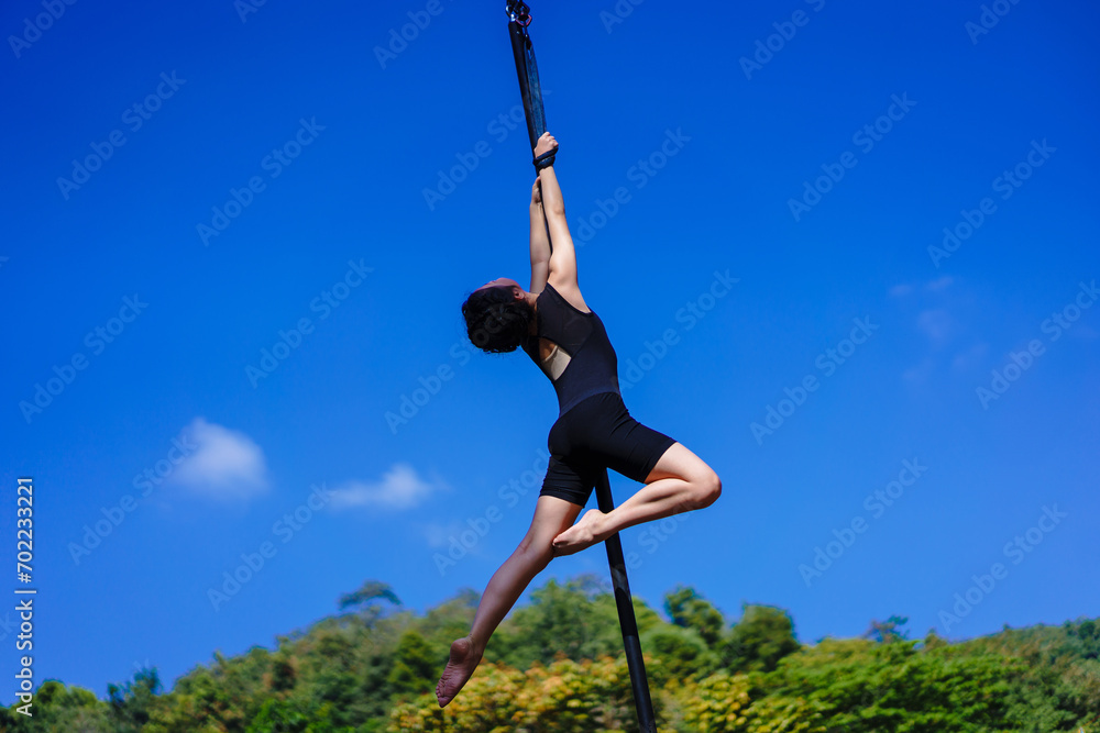 Beautiful Asian girl shows extreme advances by performing pole dance ...