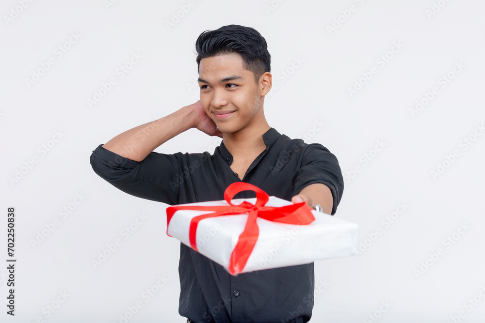 A bashful male suitor handing over a nice gift to someone. Wearing ...