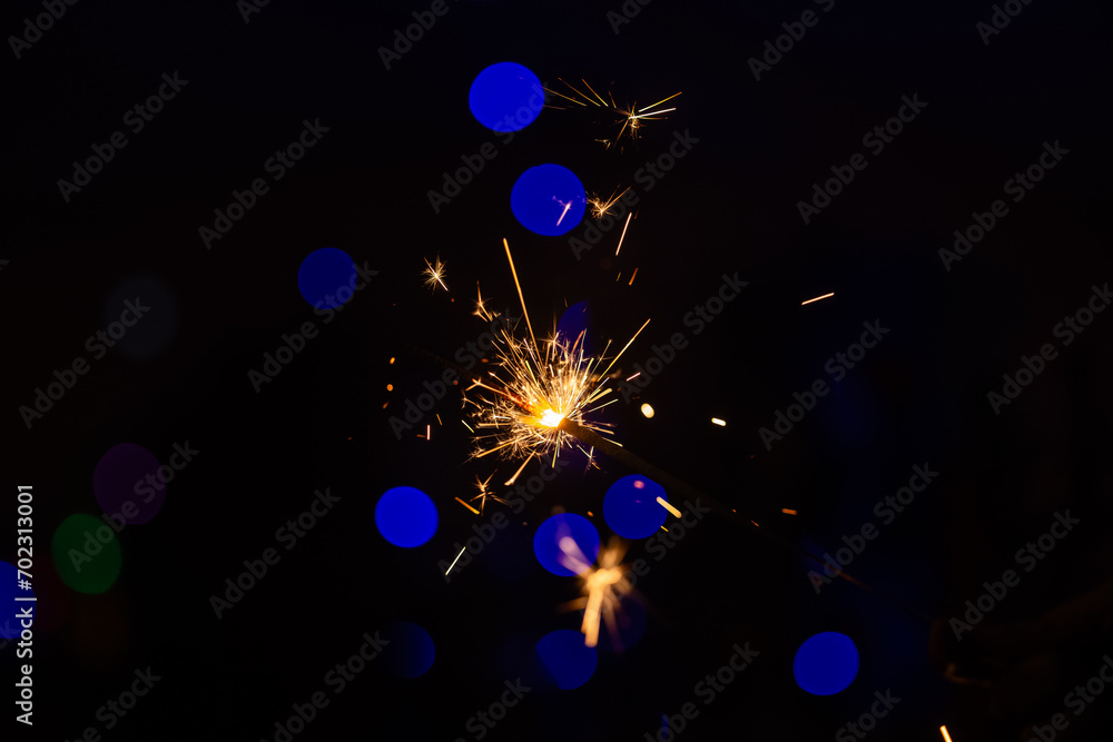 Sparkler or Fuljhadi in hand with dark black background with colorful ...