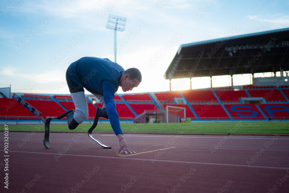 Disabled athletes prepare in starting position ready to run on stadium ...