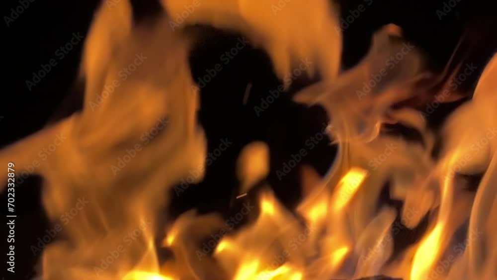 Open fire burning on black background in slow motion. Close up of ...