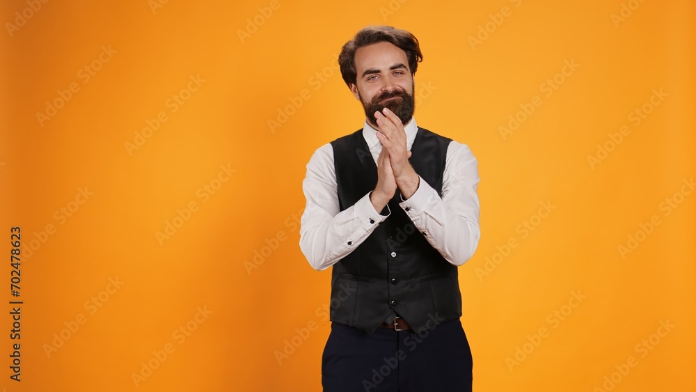 Positive butler clapping hands on camera, applauding to express ...
