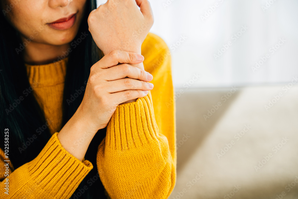 A woman experiences wrist pain or Carpal Tunnel Syndrome holding her ...