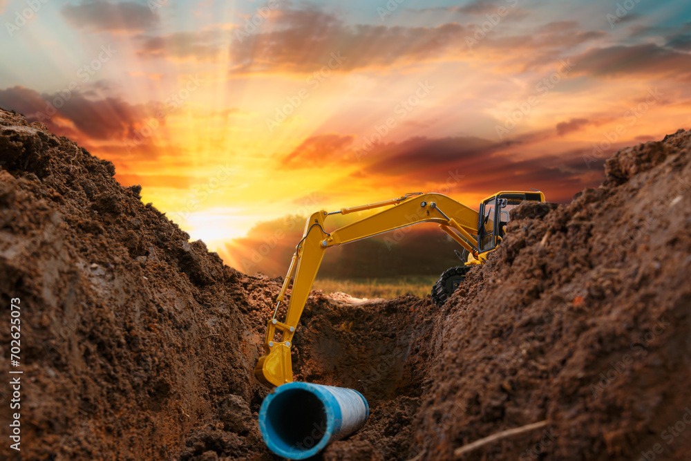 Crawler excavator is digging in the construction site pipeline work on ...