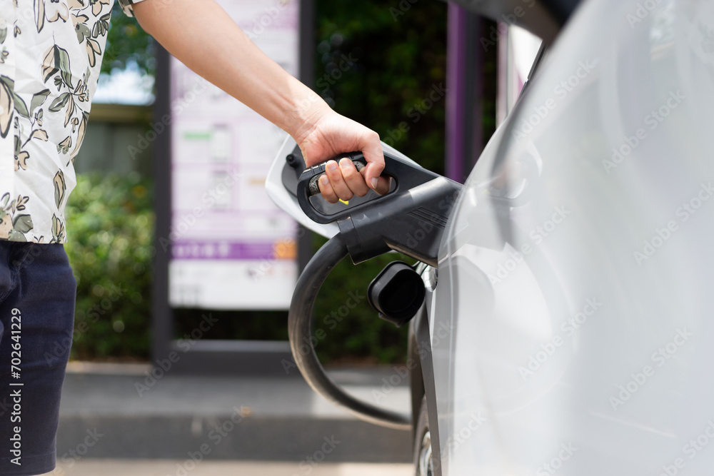 Electric car charging at the station. Sustainability and renewable ...