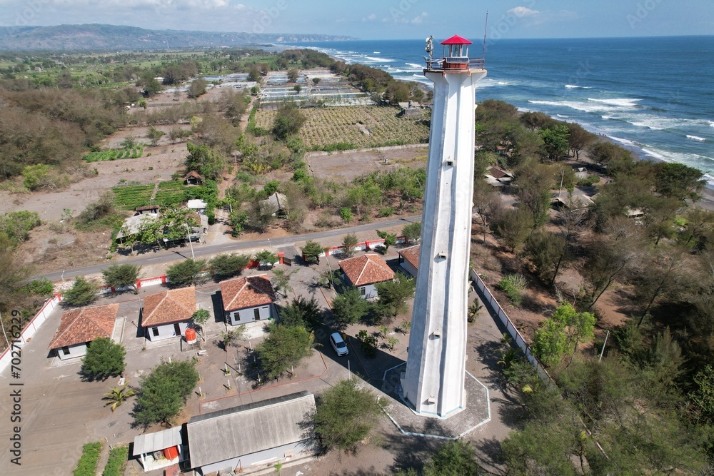 aerial view of white-walled lighthouse. A lighthouse is a tower ...