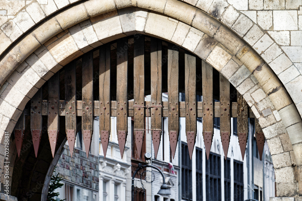 wooden portcullis with metal spikes at a medieval gate castle in the ...