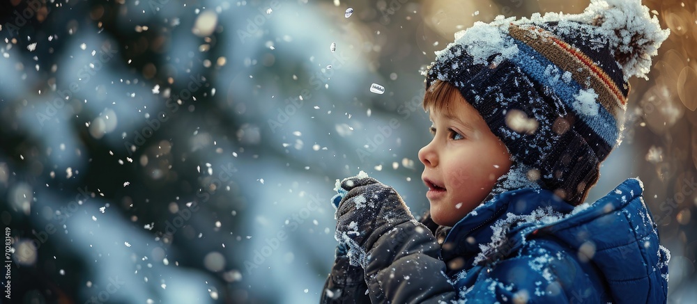 Headshot of preteen boy having fun playing with icicle on winter day ...