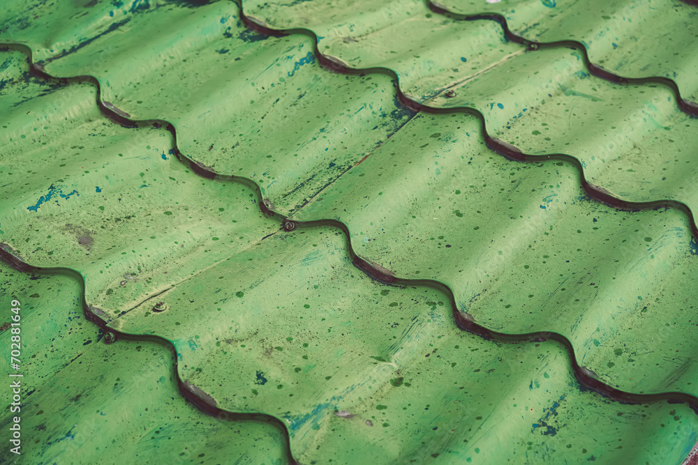 Close up of element of green tiled roof surface of residential cottage ...