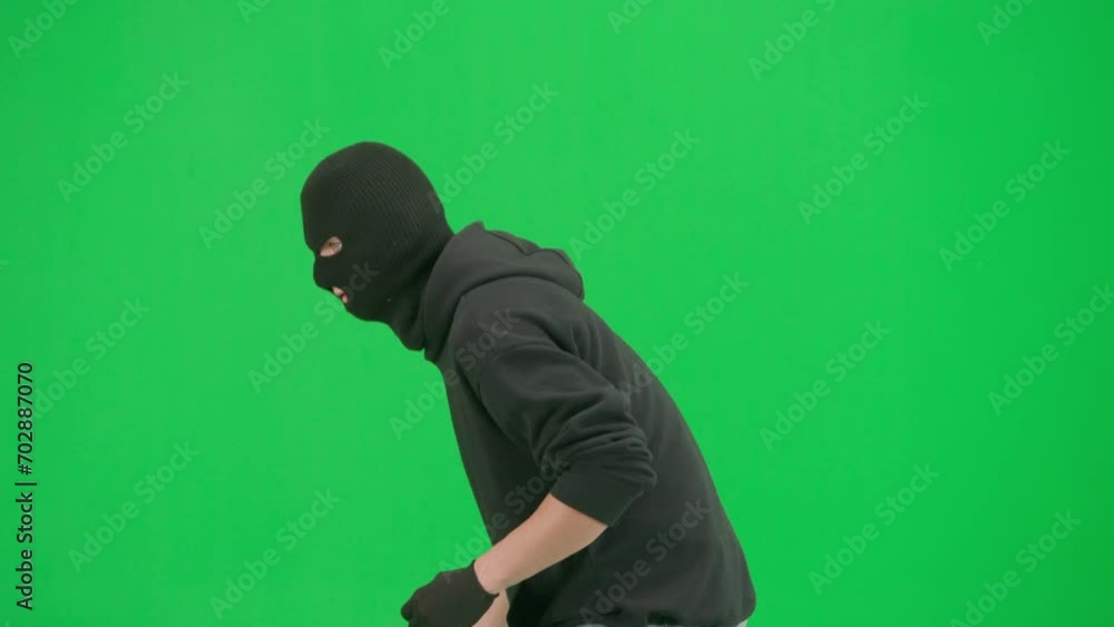 Portrait of thief on chroma key green screen background. Man robber in ...