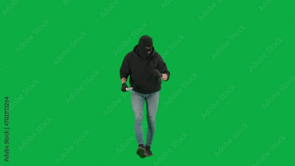 Portrait of thief on chroma key green screen background. Man robber in ...