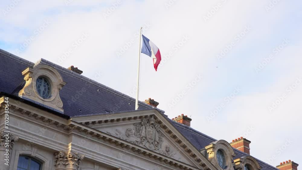 Drapeau français tricolore flottant au vent sur un monument de Paris ...
