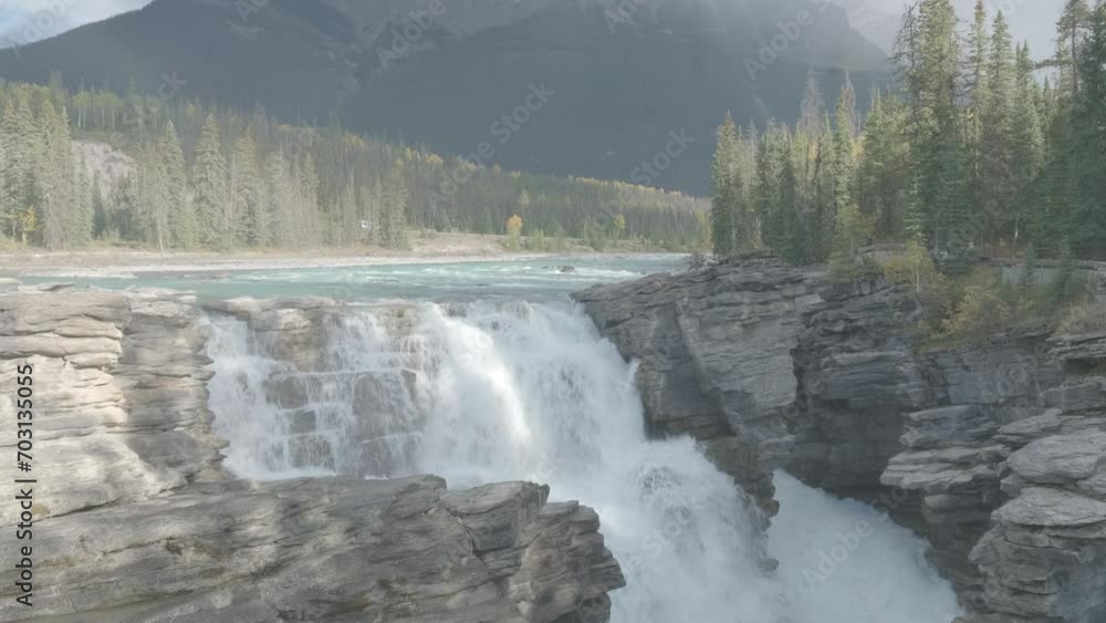 Waterfall cascading through rocky landscape in a natural forest ...