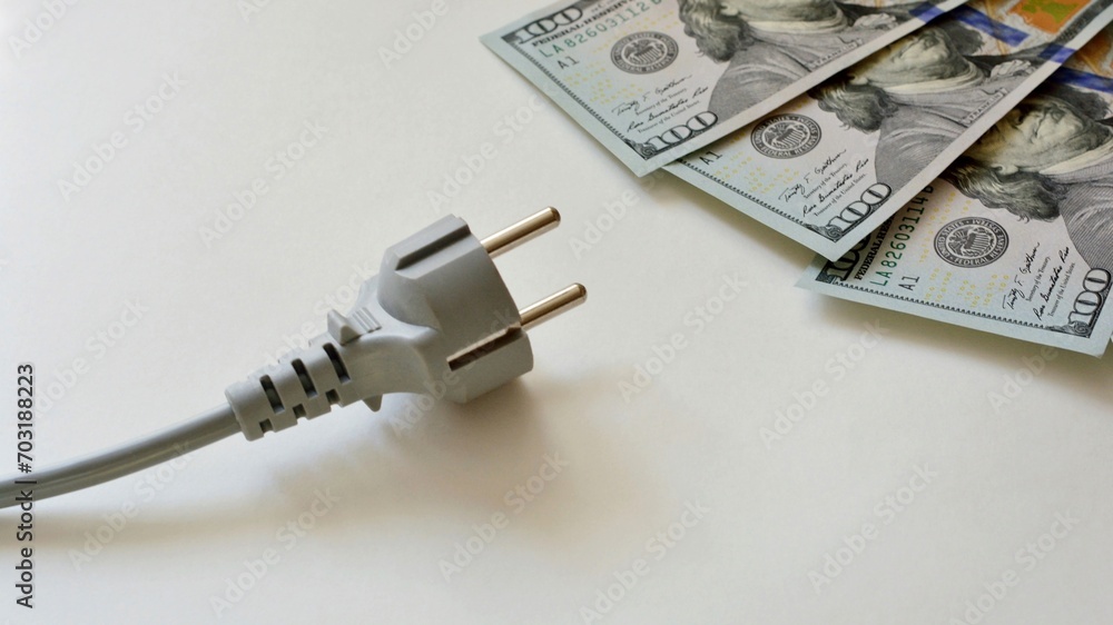 Electrical plug with cable and dollar bills on a white background ...