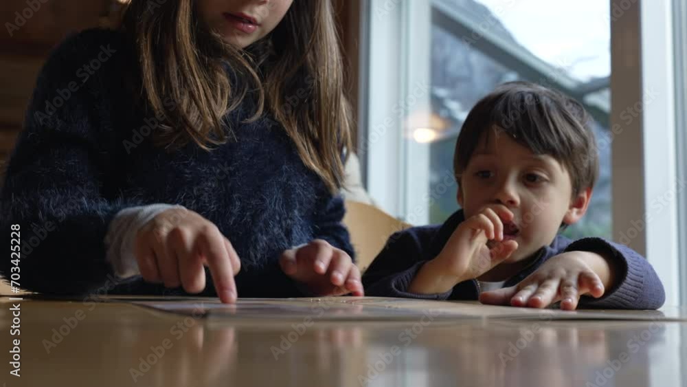 Children at restaurant picking food from menu, little 8 year old girl ...