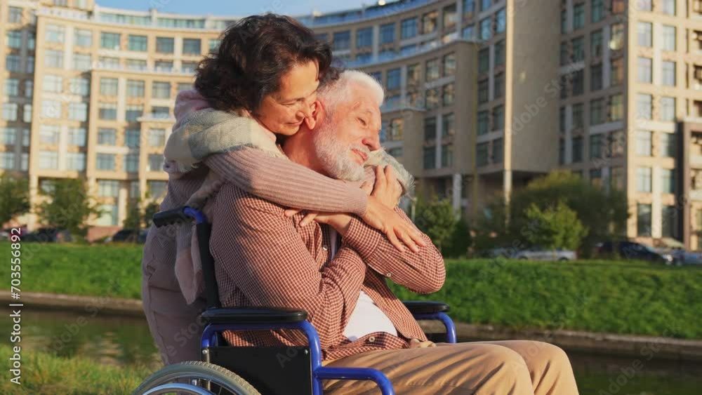 Old handicap man in wheelchair walking with caregiver senior woman in ...
