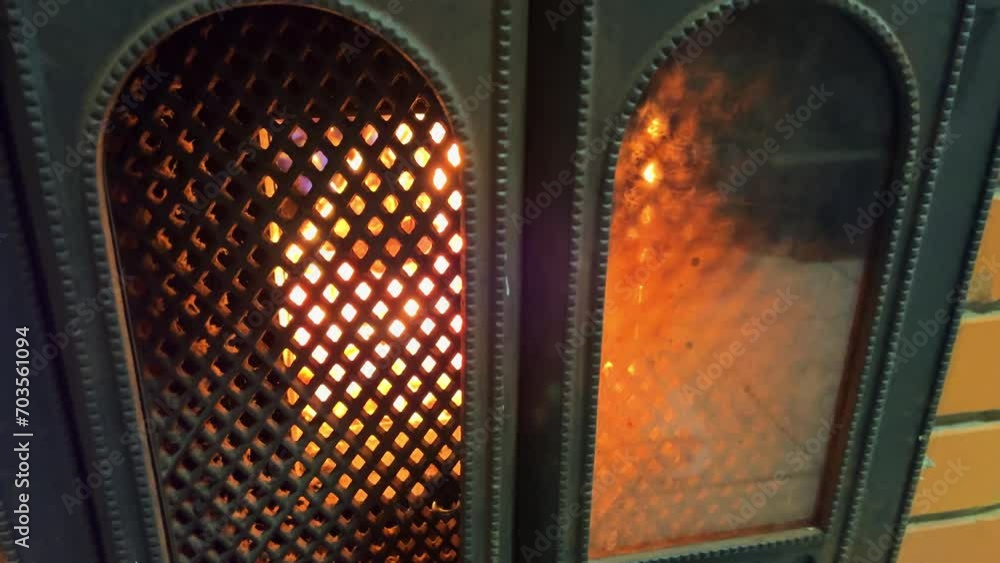 Light effect of lens flare from burning fire flames in fireplace behind ...