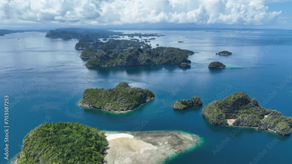 Scenic limestone islands, fringed by coral reefs, rise from the amazing ...