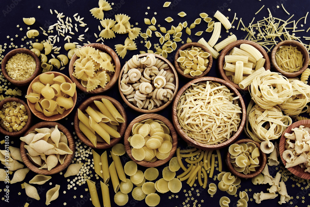 Mix of pasta shapes varieties: penne and fusilli, farfalle and macaroni ...