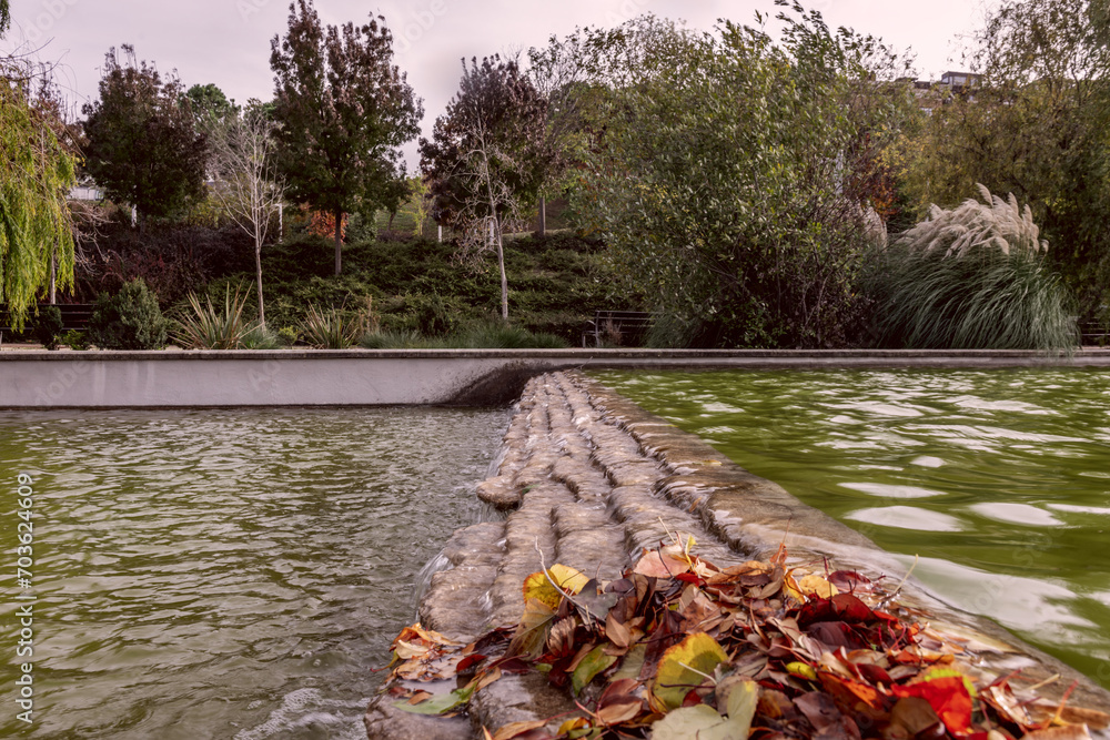 an artificial water channel with a small artificial stone waterfall ...