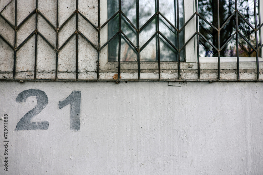 House numbering. The number 21 twenty one is painted using a stencil on ...
