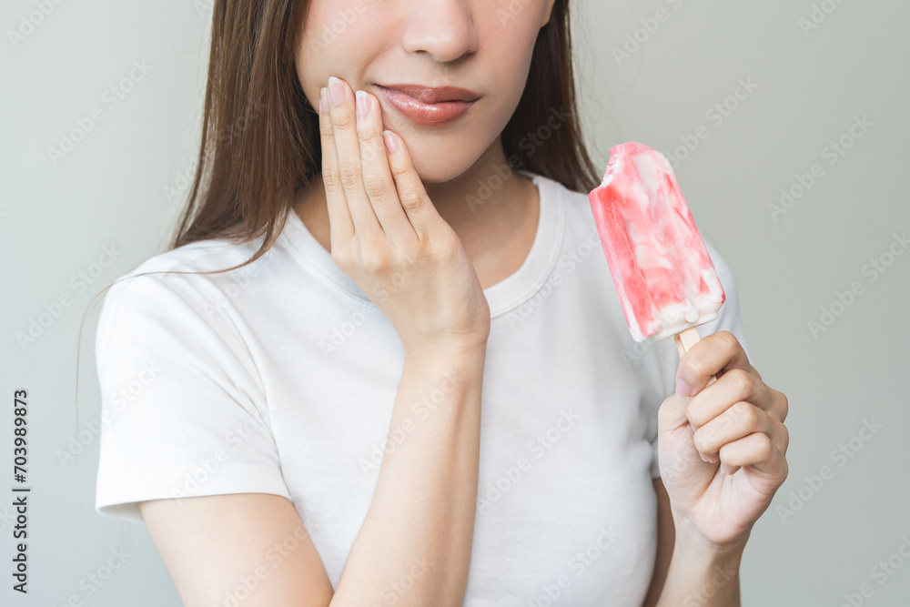 Face expression suffering from sensitive teeth and cold, asian young ...