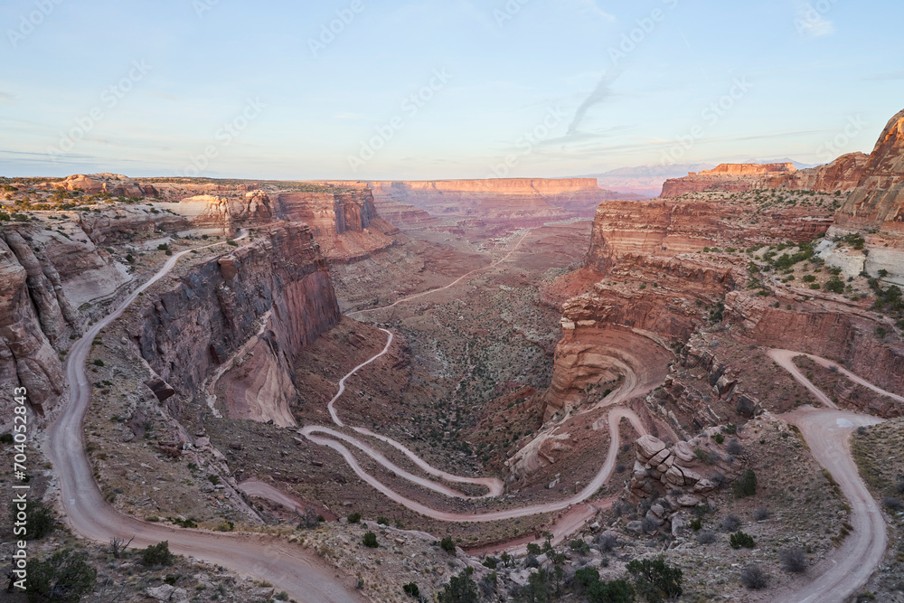 Squiggly road leads down into the canyon, following several curves and ...