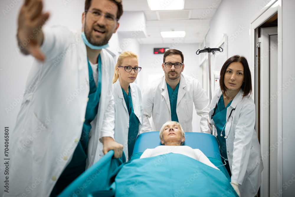 Nurses and doctors in a hurry taking patient to operation theatre ...