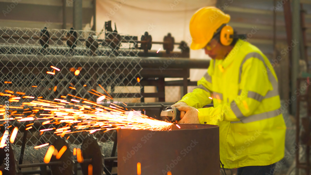 Professional heavy industry workers wearing safety suits using angle ...
