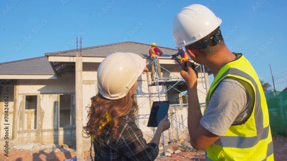 Asian male construction engineer talking to Asian female architects ...