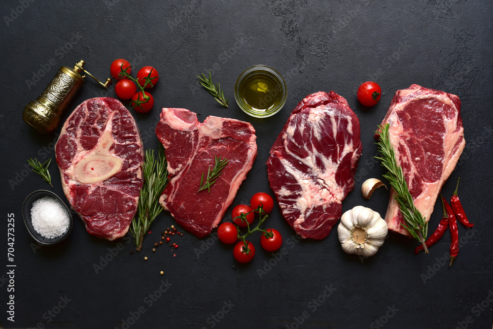 Different types of raw marbled beef steaks : T-bone, ossobuko, spider ...
