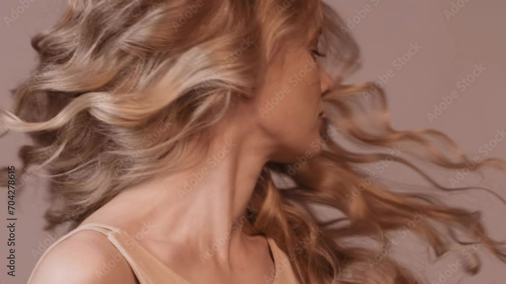 Woman turns his head, waving her long wavy ginger hair. Female hair ...