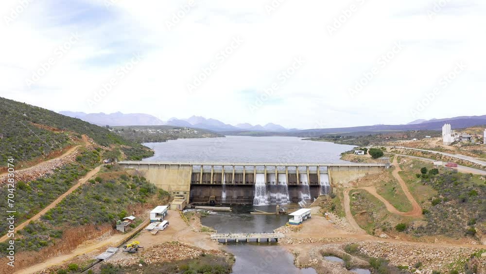 Drone, dam and wall, industrial landscape and water source outdoor with ...