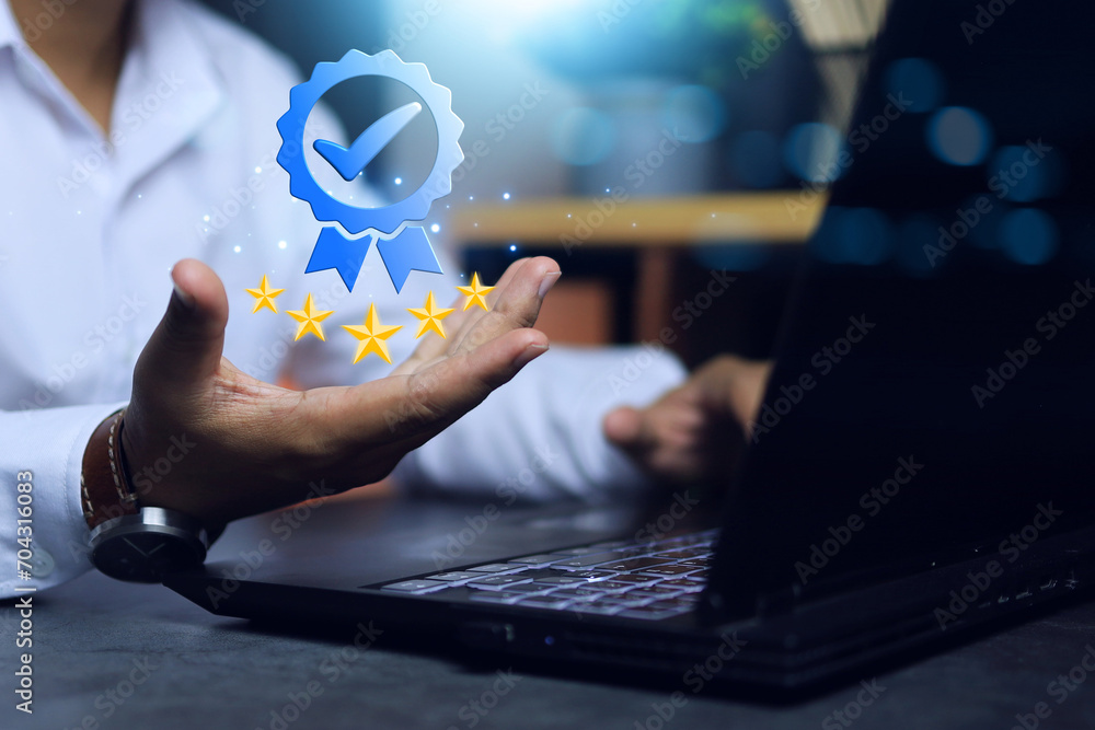 Businessman hold a 5 star quality certification mark indicating the ...