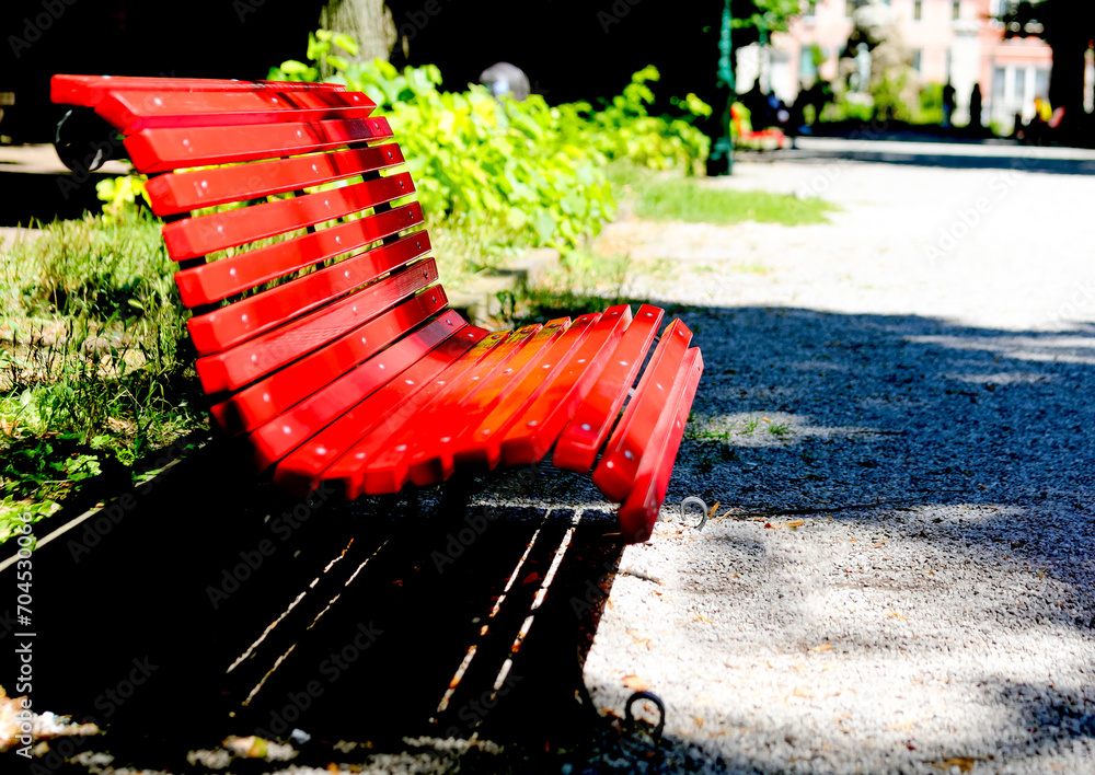 red wooden bench in the park with intense intentionally lively colors ...