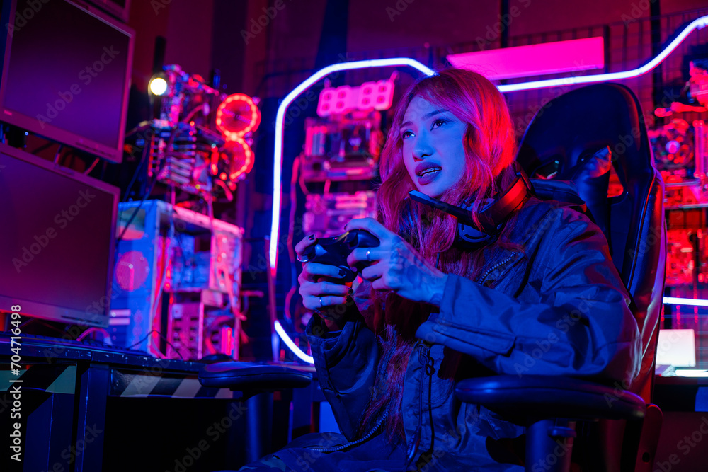 Woman wear gaming headphones playing esports games console gaming room ...