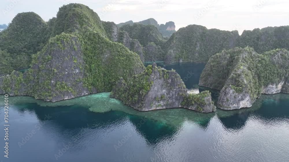 Scenic limestone islands, fringed by coral reefs, rise from the amazing ...