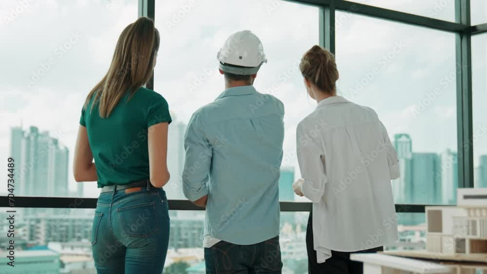 Smart architect engineer team in casual outfit talking while look at ...
