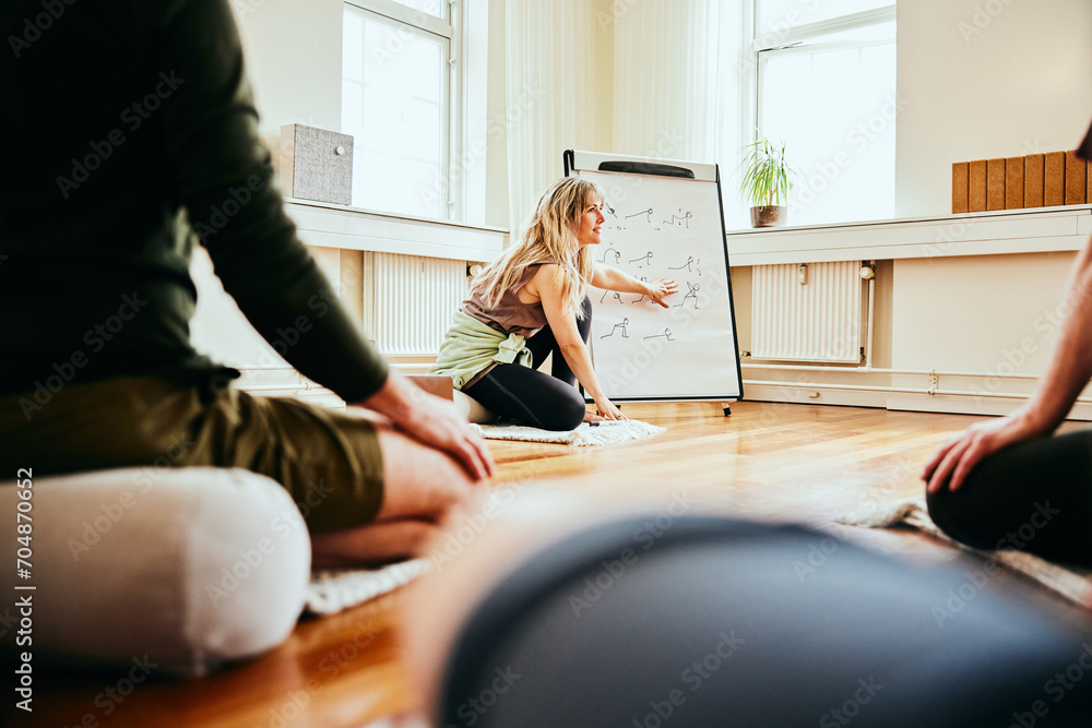 Yoga intstructor teaching students poses Stock Photo | Adobe Stock