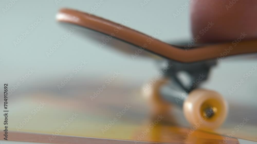A hyper close-up macro detailed shot of a mini skateboard, tiny white ...