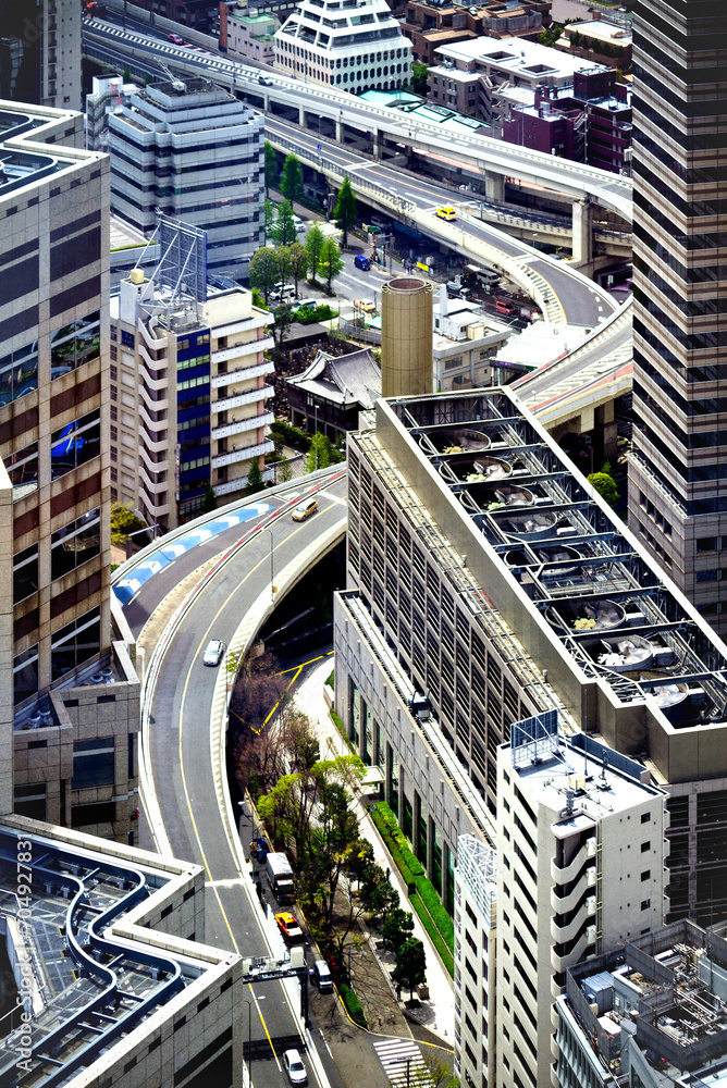 a freeway passes through several tall buildings in the city of tokyo ...