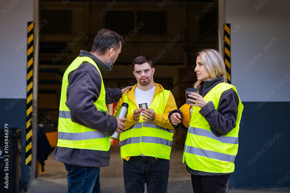 Man with Down syndrome and his colleagues taking break from work ...