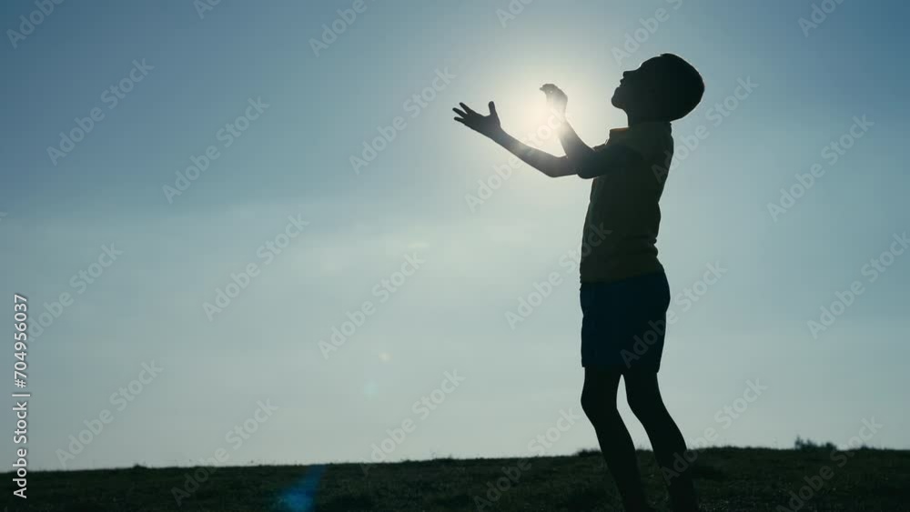 Kid Throwing a Ball and Catching It in a Shillouette as Sun Shines ...