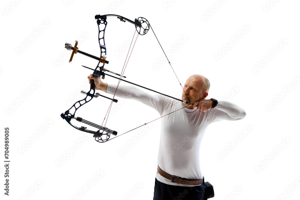 Man in his 40s, archery athlete with bow and arrow aiming at archery ...