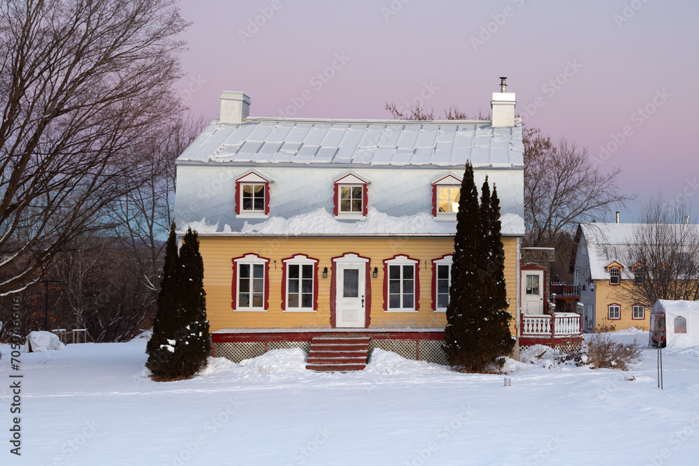 Sunrise winter view of beautiful patrimonial yellow clapboard house ...