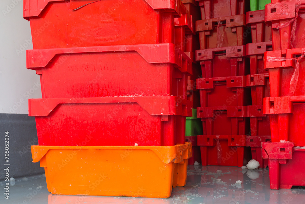 stacked red plastic packing crates in the back of a refrigerated truck ...